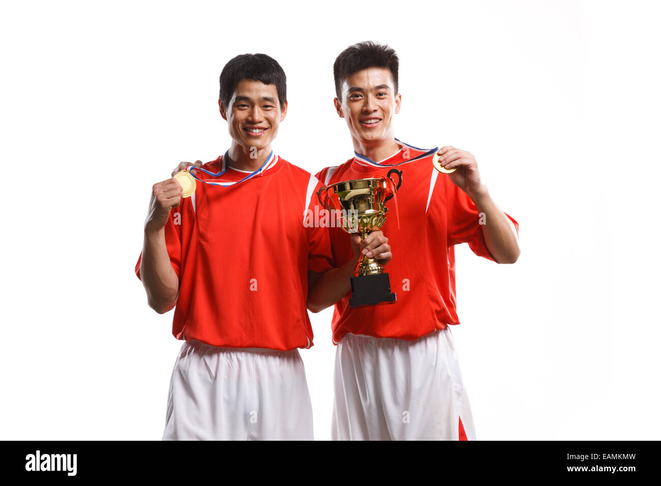 Football players celebrate success with a gold medal Stock Photo - Alamy