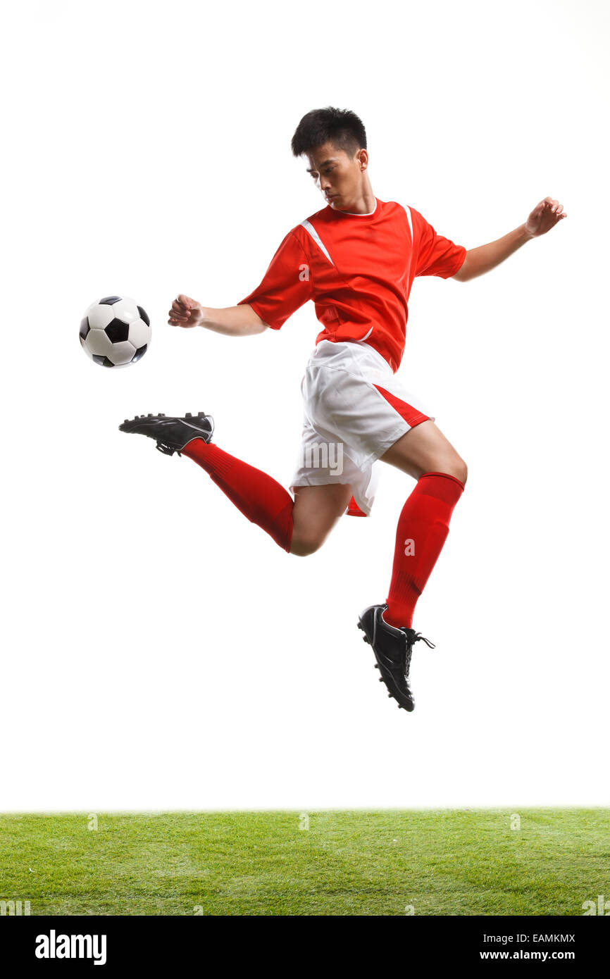 A football player is playing football Stock Photo - Alamy