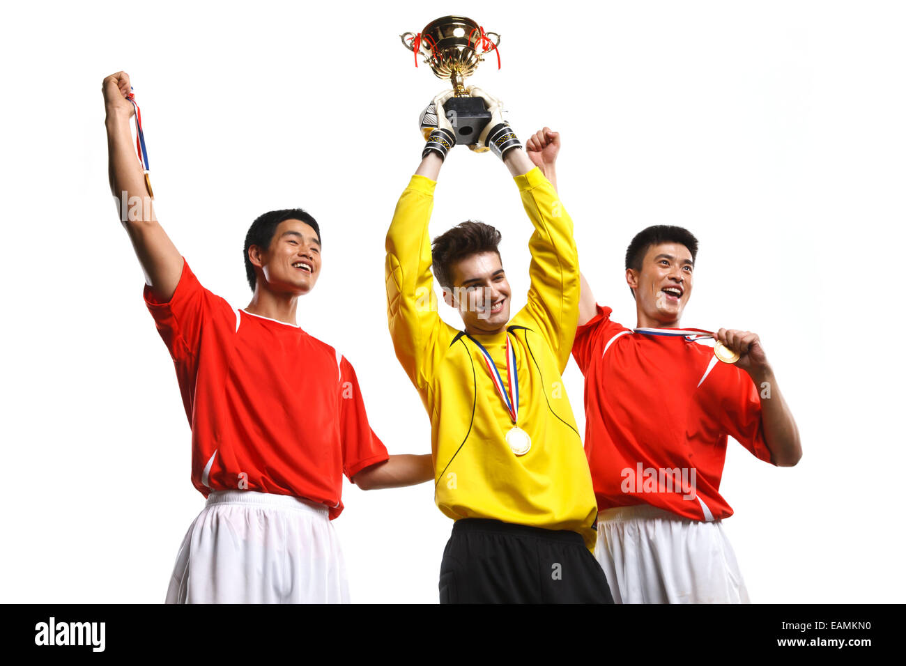 Three football players celebrate your success Stock Photo - Alamy