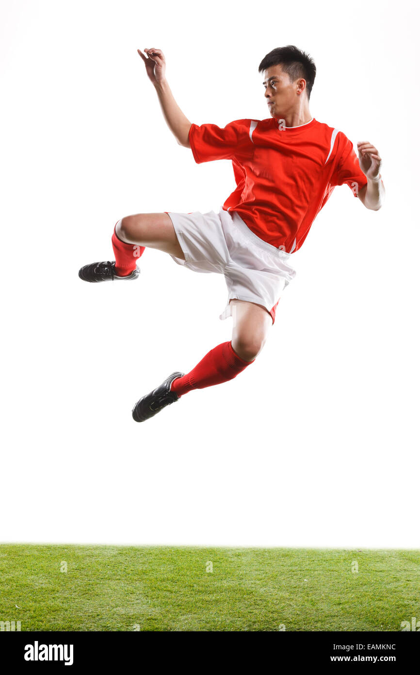 Football players jumping to play in midair Stock Photo - Alamy