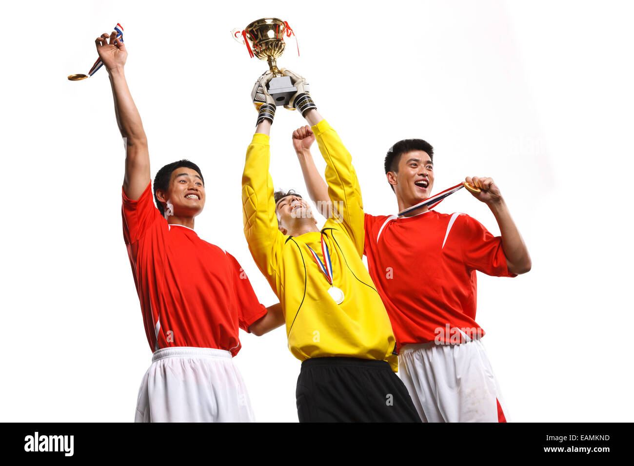 Three football players celebrate your success Stock Photo - Alamy