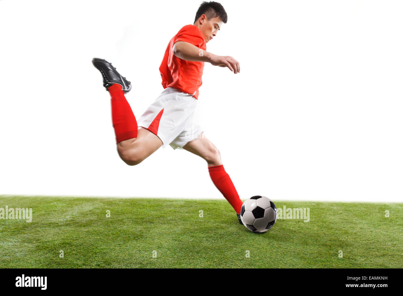 A football player is playing football Stock Photo - Alamy