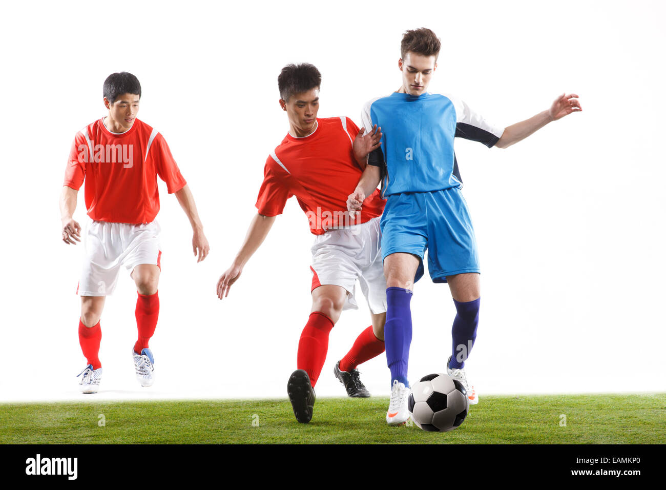 Three football players in football Stock Photo - Alamy
