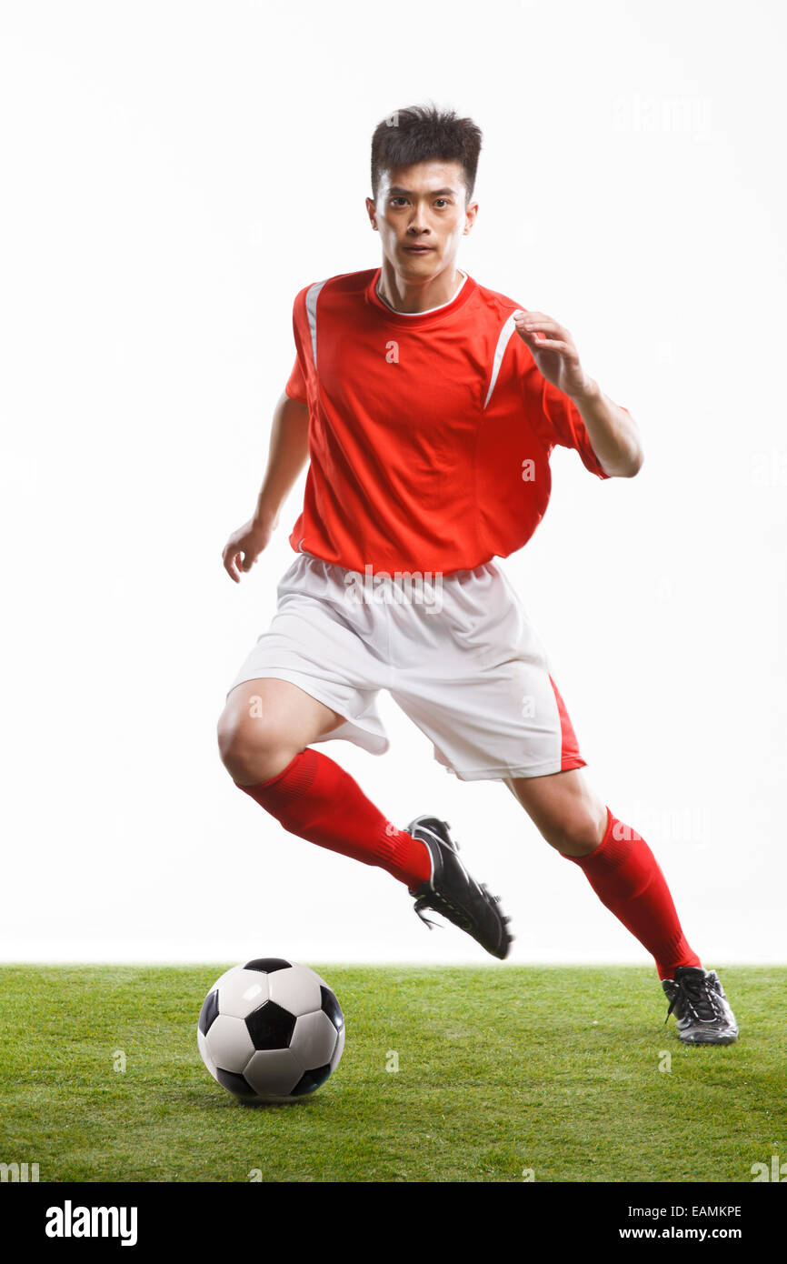 A football player is playing football Stock Photo - Alamy