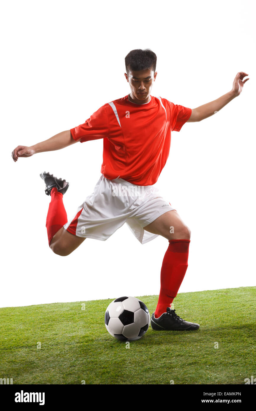 A football player is playing football Stock Photo - Alamy