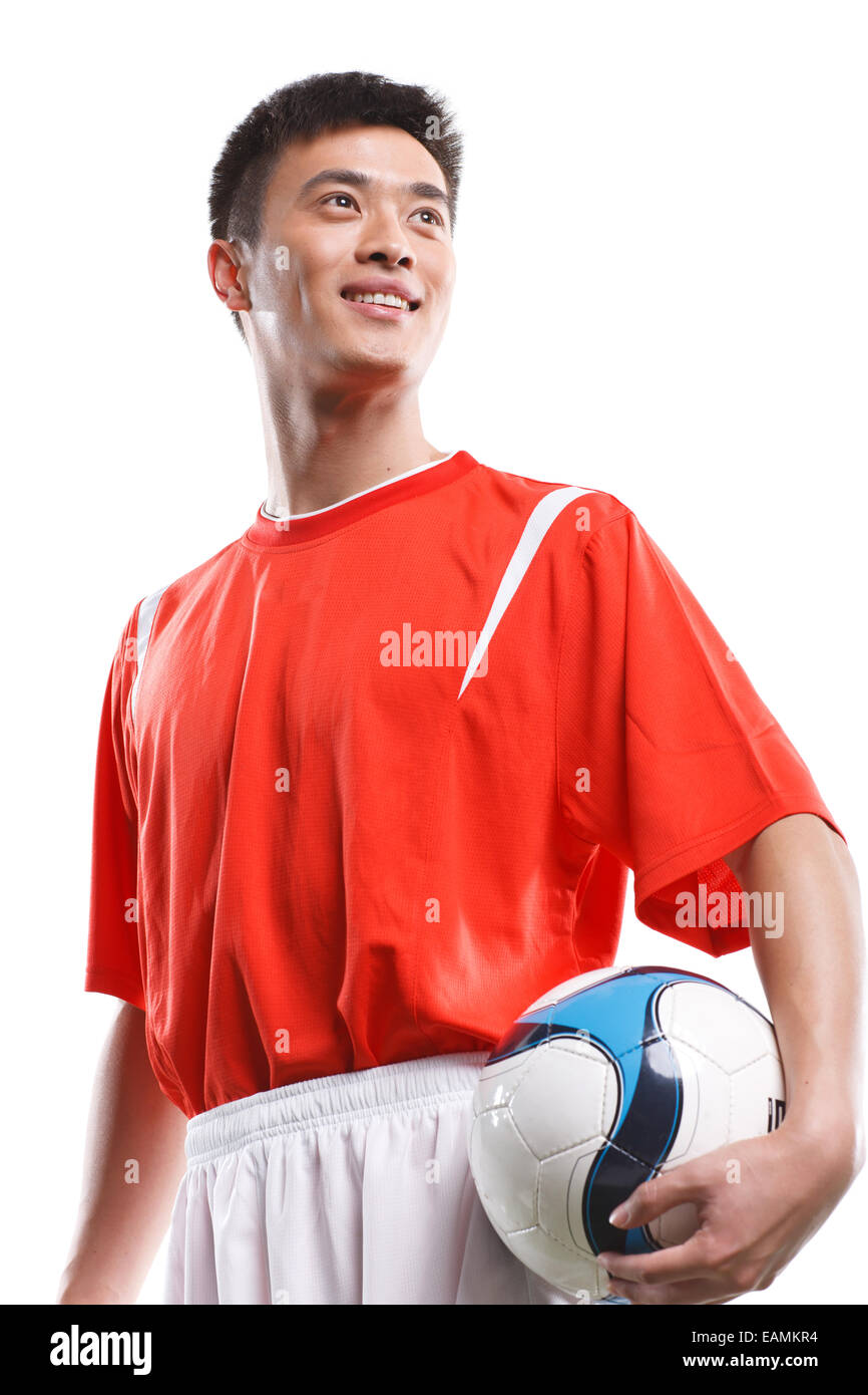 Confident football player with a football Stock Photo - Alamy