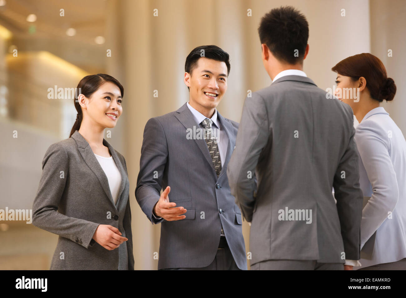 Four business people to talk Stock Photo - Alamy