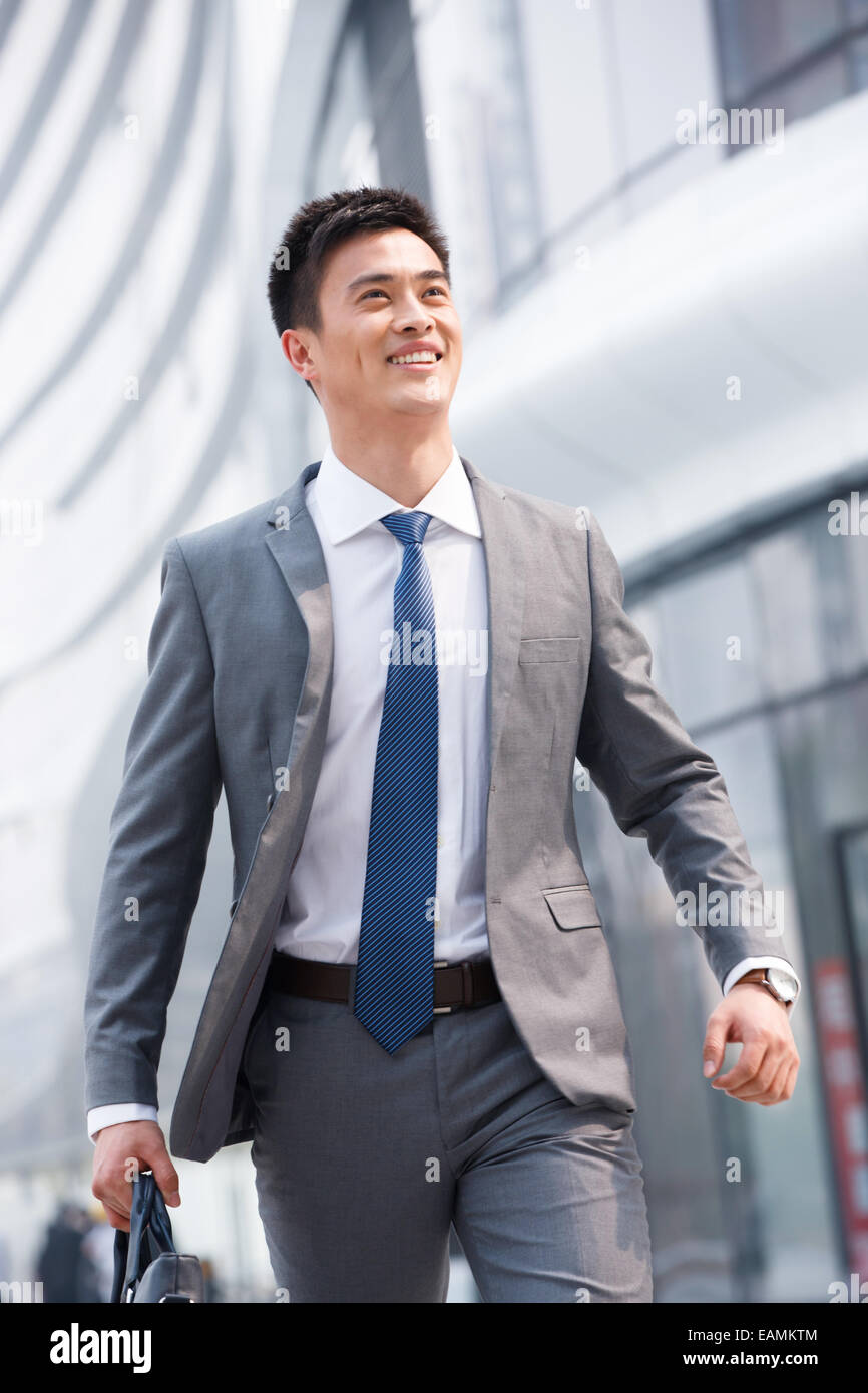 An Oriental business man on his way to work Stock Photo - Alamy