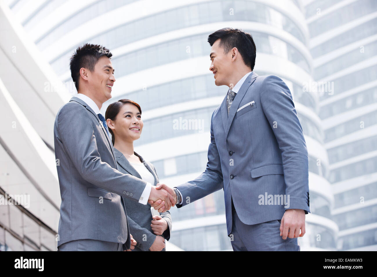 Three business people to talk Stock Photo - Alamy