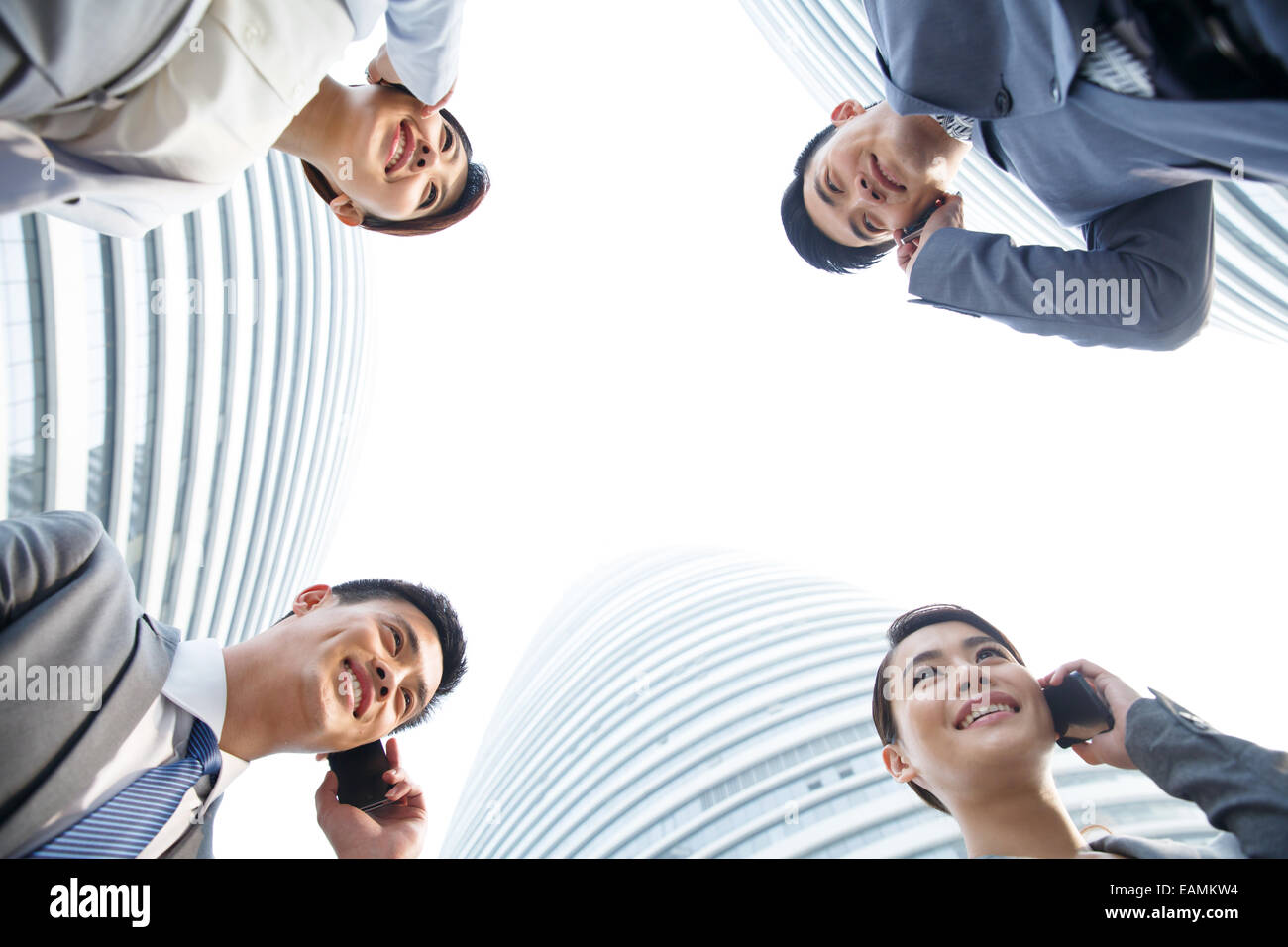 Four east business people make a phone call Stock Photo - Alamy