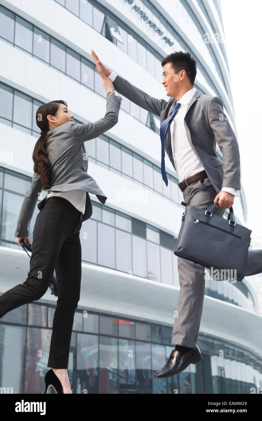 Two business people clapping to celebrate success Stock Photo - Alamy