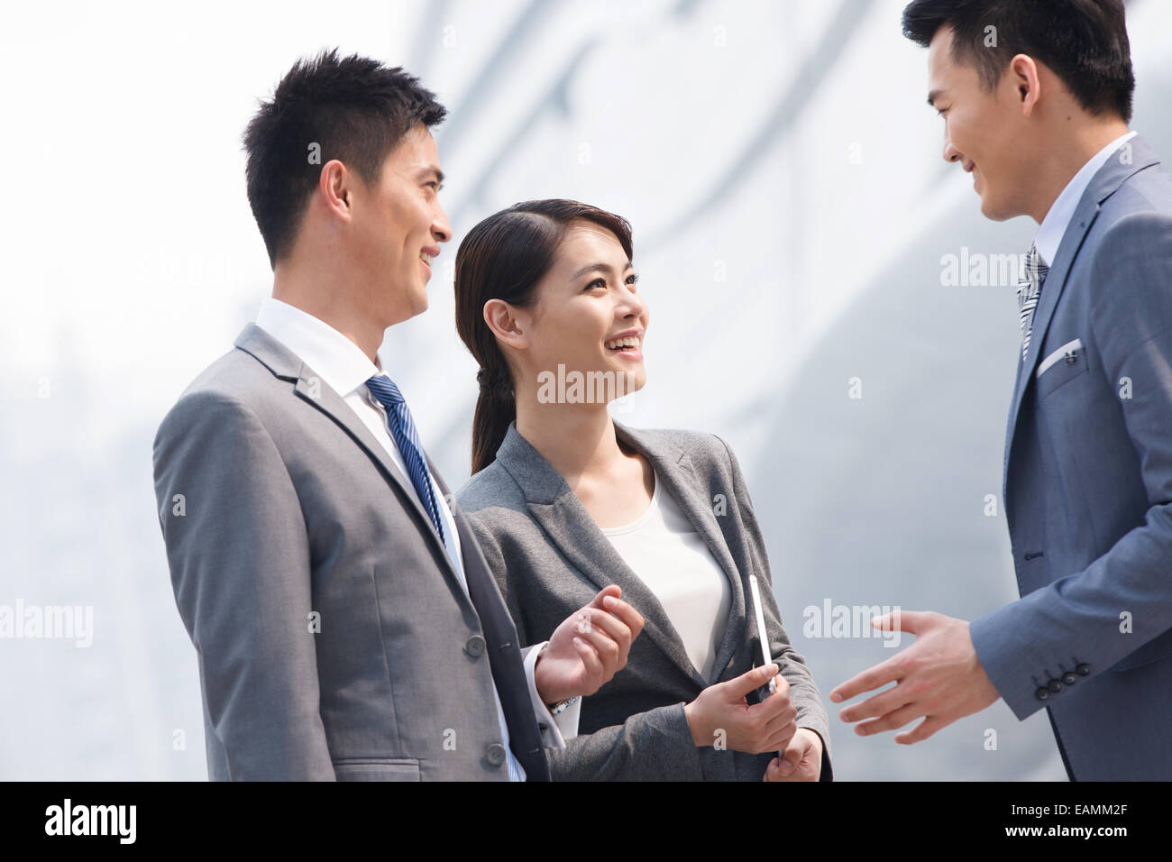 Three business people to talk Stock Photo - Alamy
