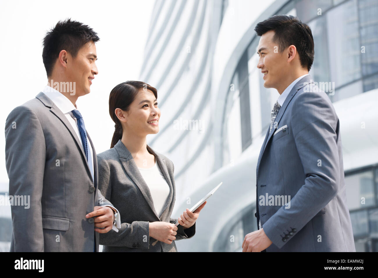 Three business people to talk Stock Photo - Alamy
