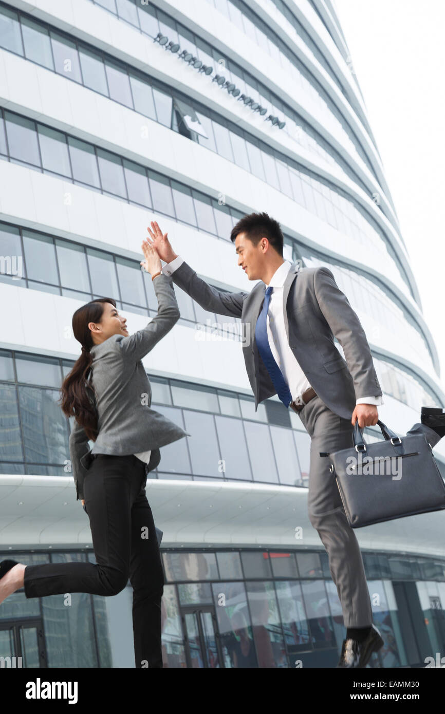 Two business people clapping to celebrate success Stock Photo - Alamy