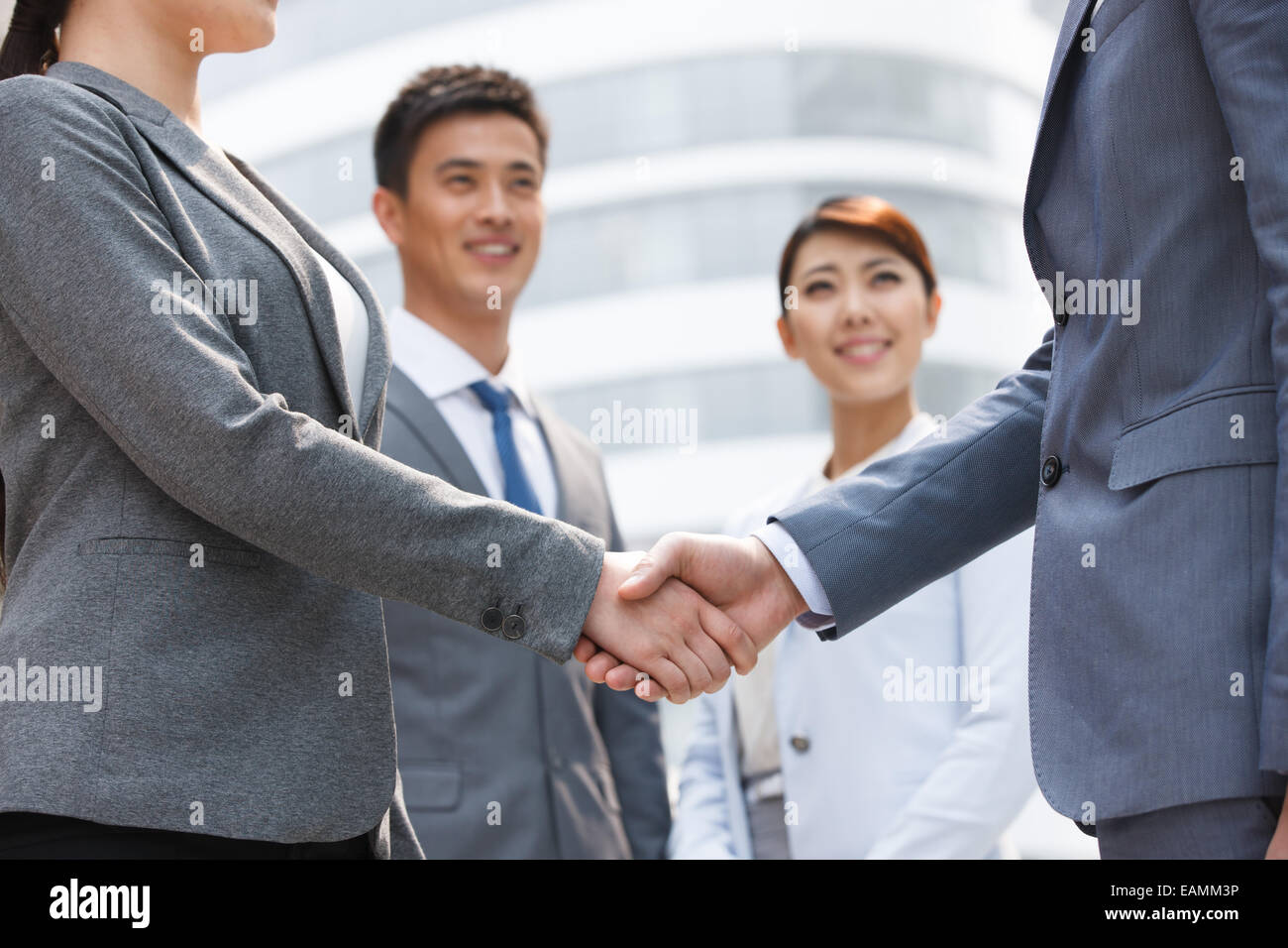 The eastern business people shake hands Stock Photo - Alamy