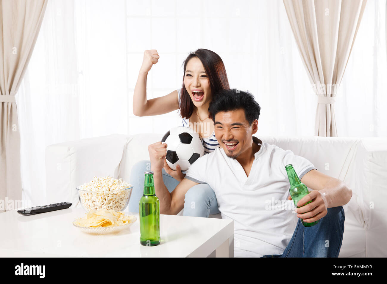 Couples fans watch the game Stock Photo - Alamy
