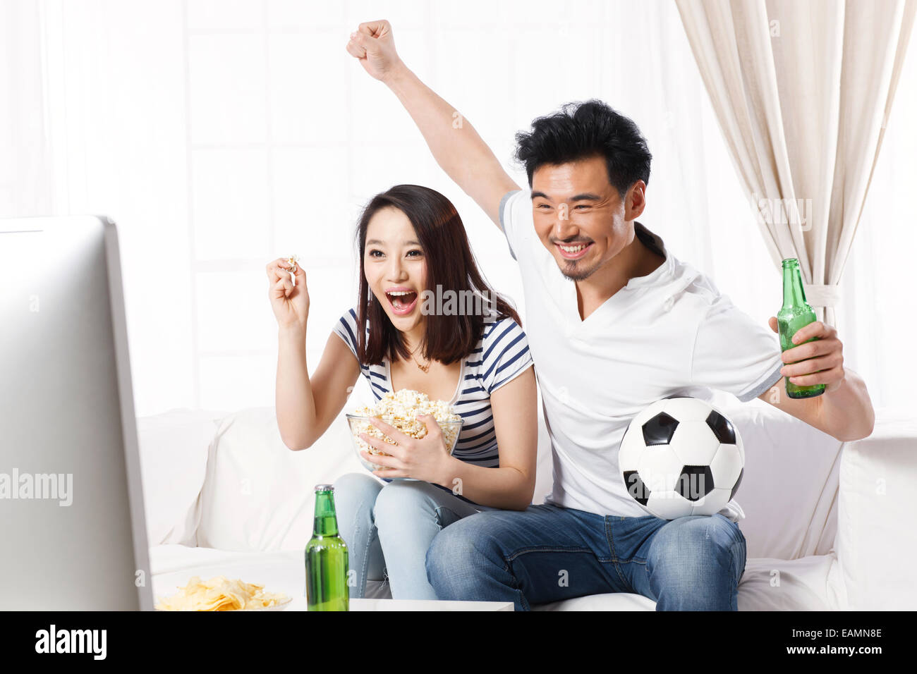 Couples fans watch the game Stock Photo - Alamy