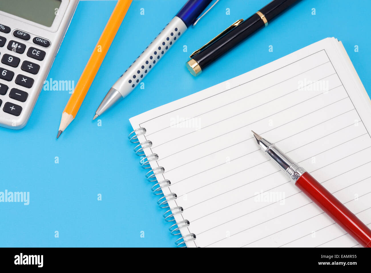 pencil, calculator and ink pen on notepad Stock Photo - Alamy