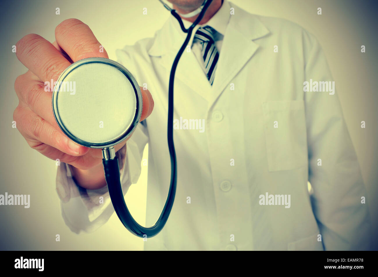 doctor holding a stethoscope in the air like he would auscultate the ...