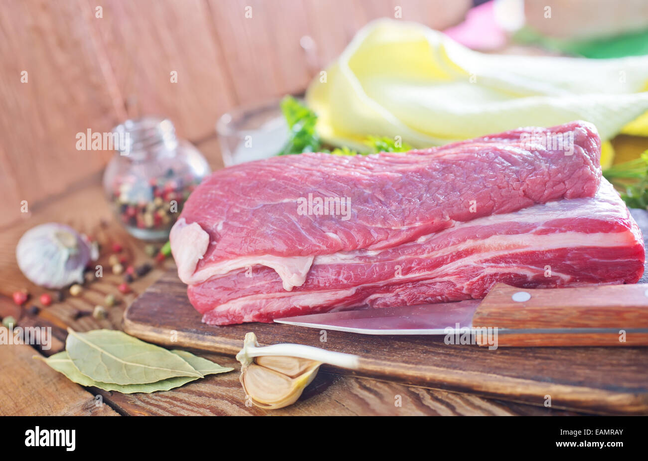 raw meat on the wooden board and on a table Stock Photo - Alamy