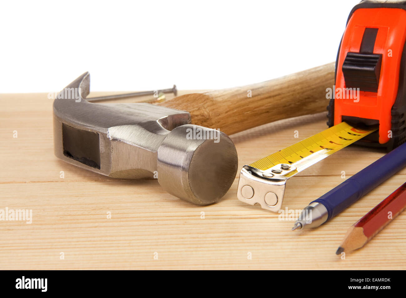 hammer, tape measure, pen and pencil on wood brick Stock Photo - Alamy