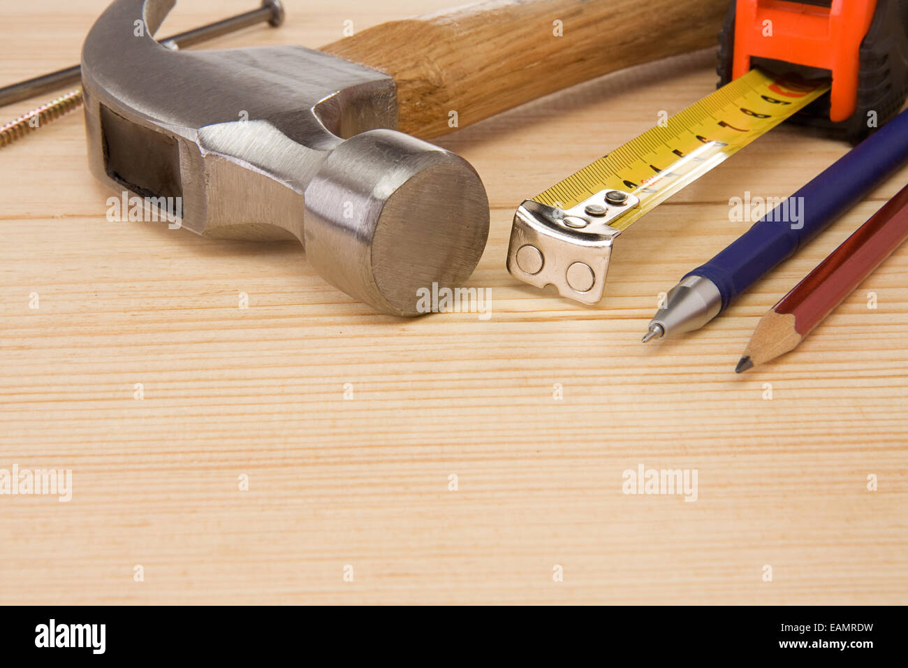 hammer, tape measure, nail and pencil on wood brick Stock Photo - Alamy