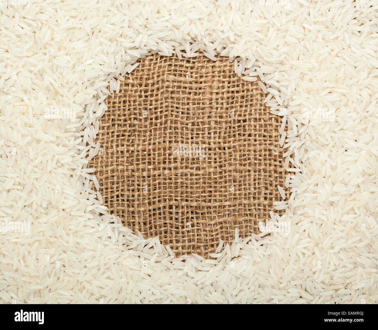 Thai fragrant jasmine rice forming a round frame on burlap fabric Stock ...