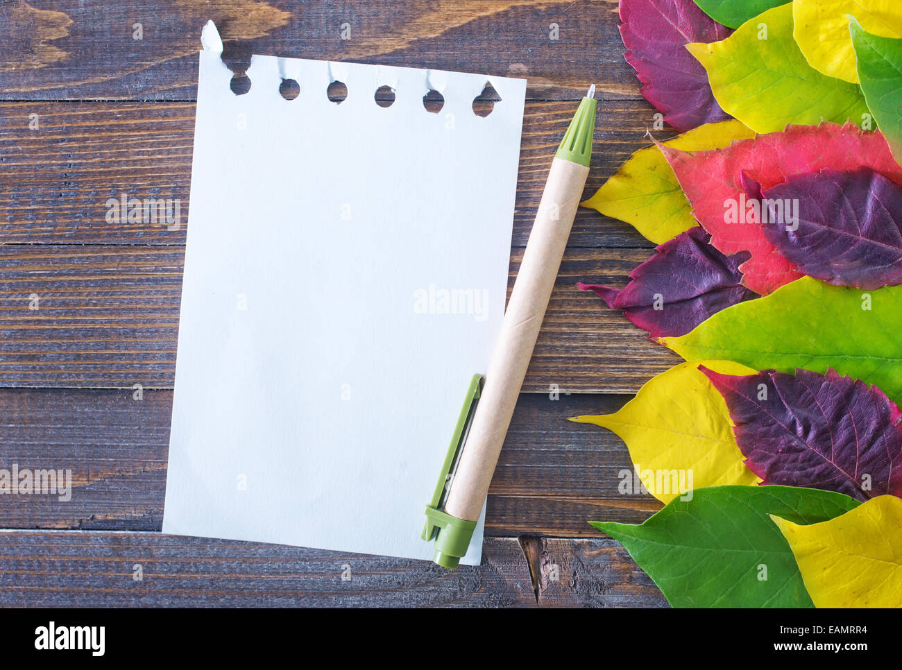 autumn leaves on the wooden background,yellow leaves and notepad Stock ...