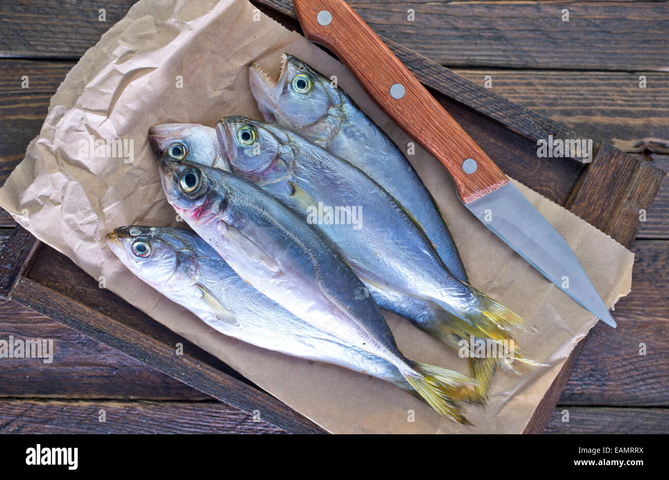 raw fish on paper and on wooden board Stock Photo - Alamy