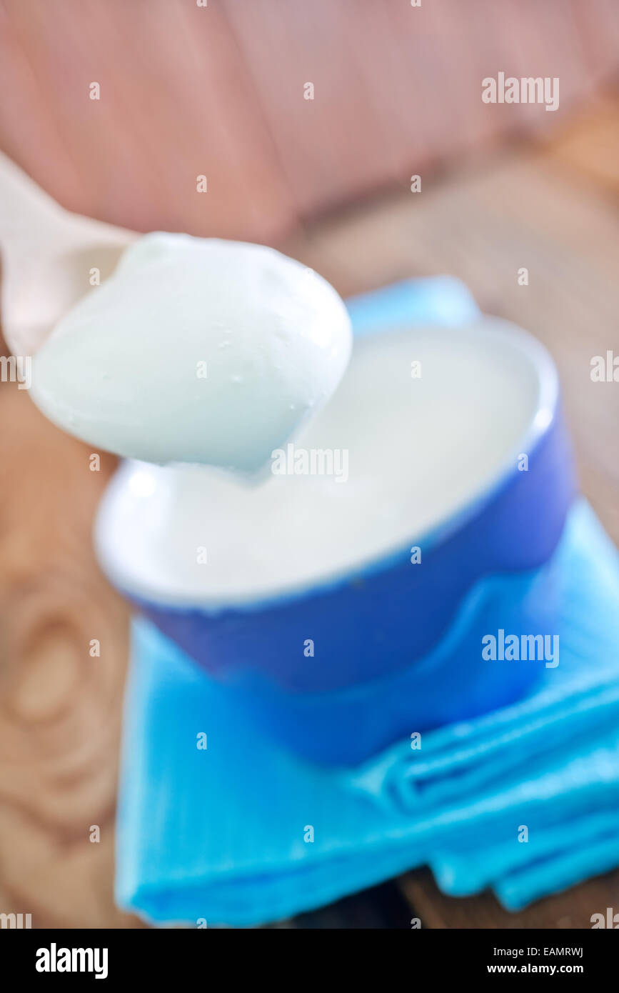 sour cream in blue bowl and on a table Stock Photo - Alamy