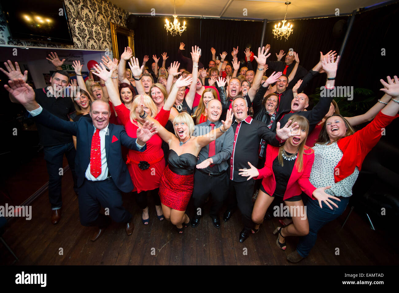 An excited group of people cheer celebrating an event Stock Photo - Alamy
