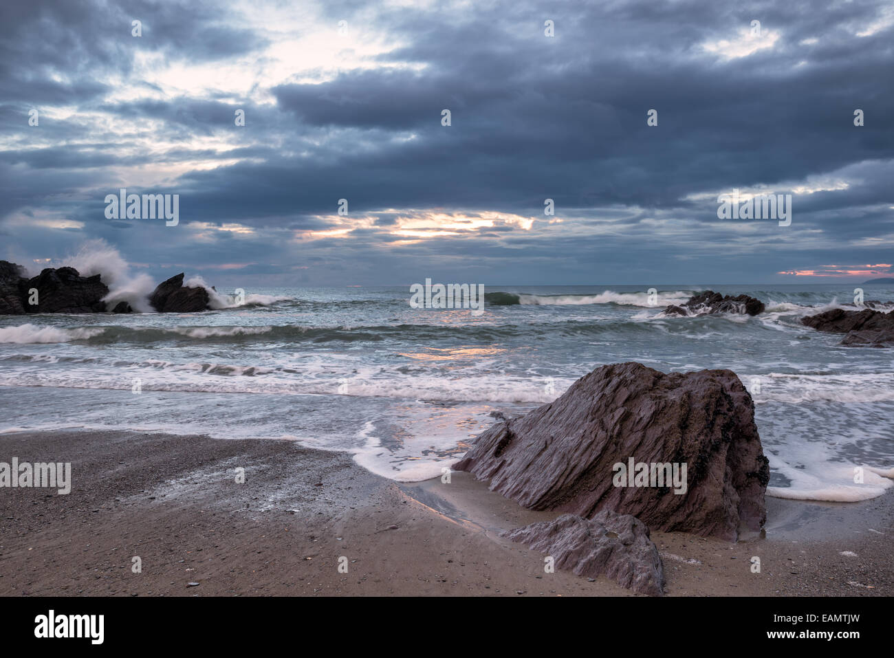Waves crashing over rocks at Sharrow Beach on the Cornwall coast Stock ...
