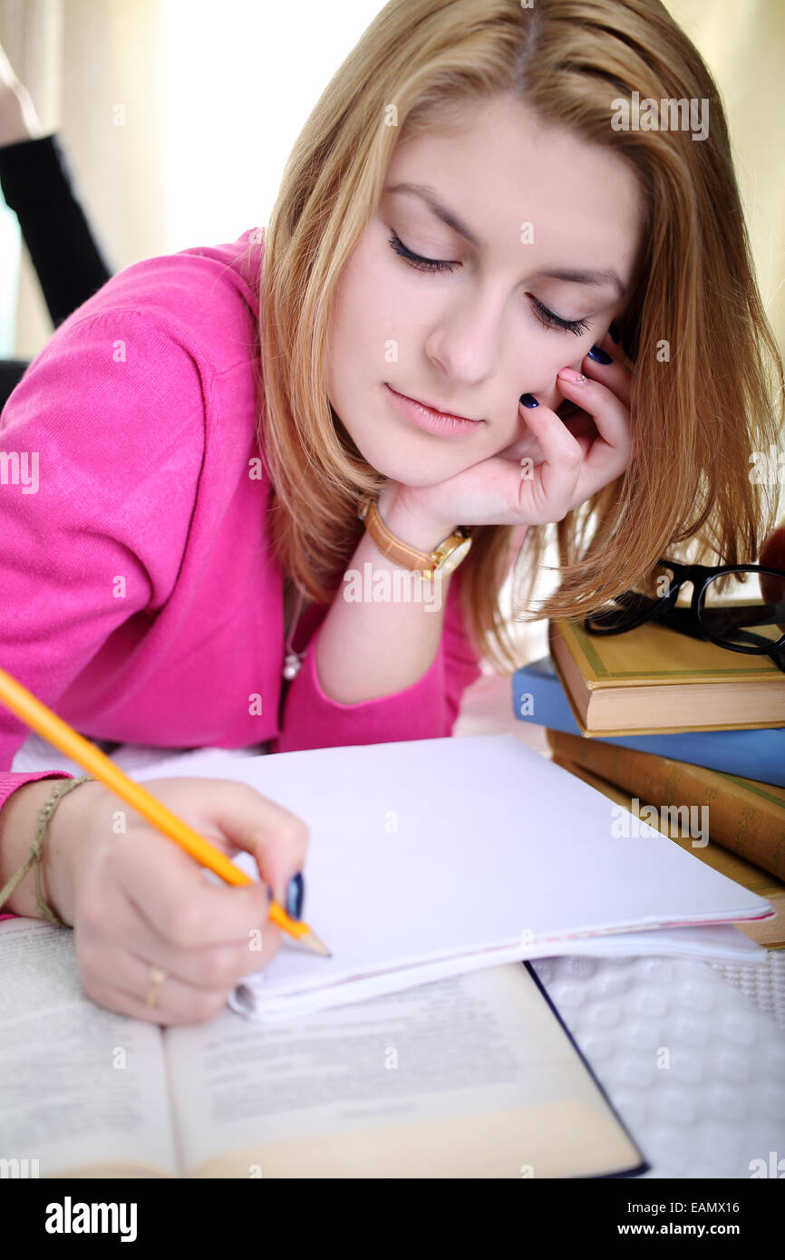 The girl writes a note in notebook Stock Photo - Alamy