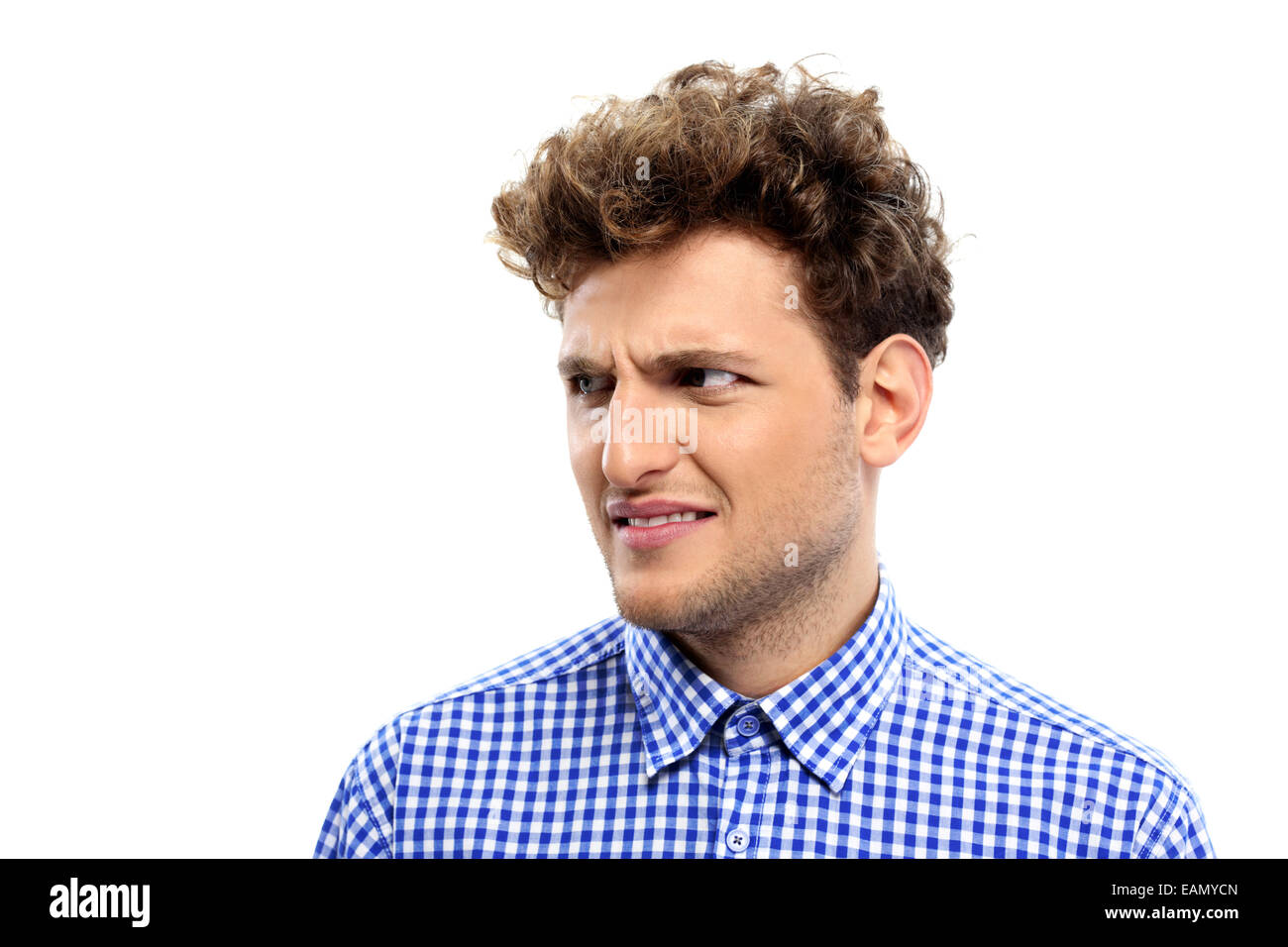 Portrait of a young disgusted man over white background Stock Photo - Alamy