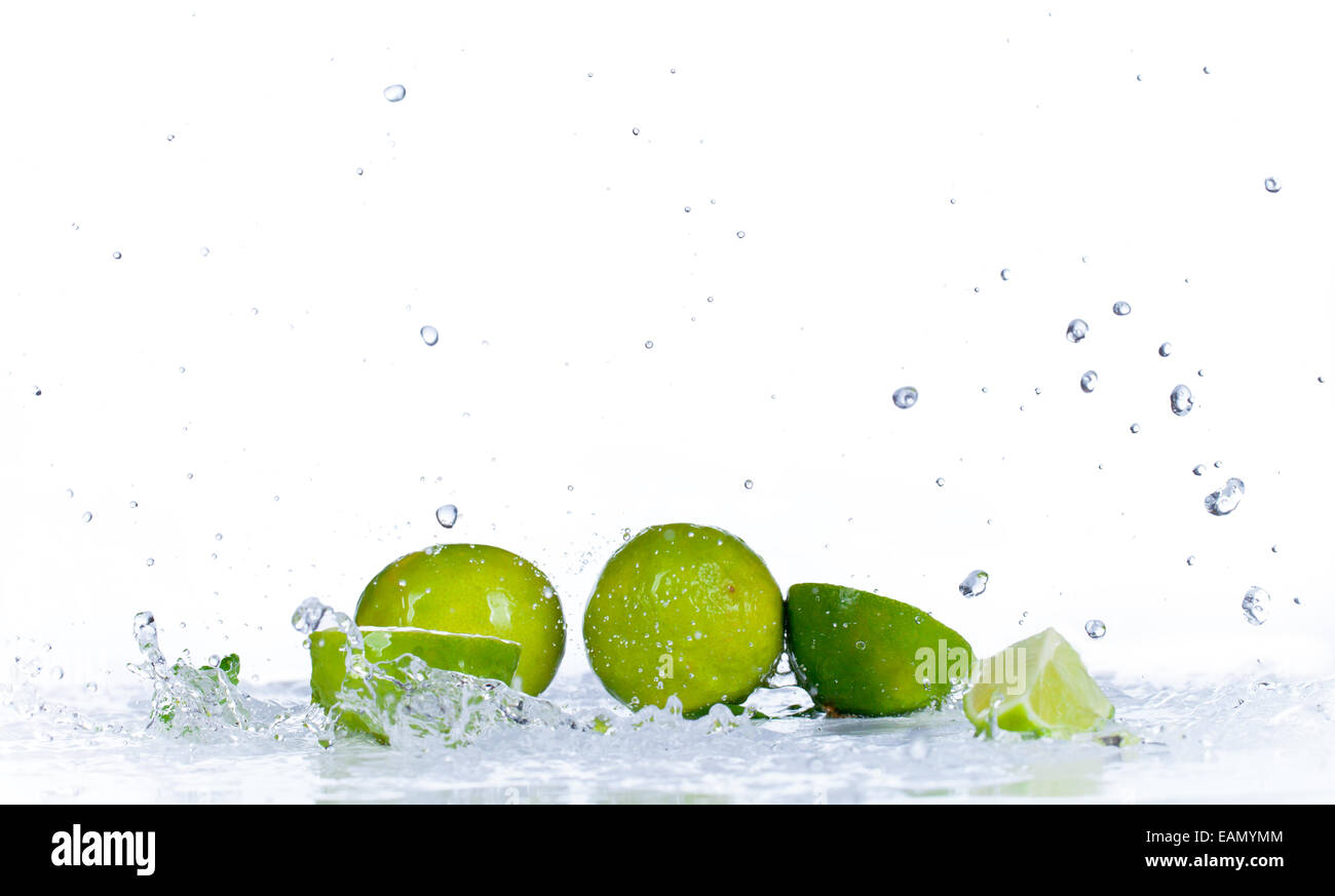 Fresh limes with water splash, isolated on white background Stock Photo ...