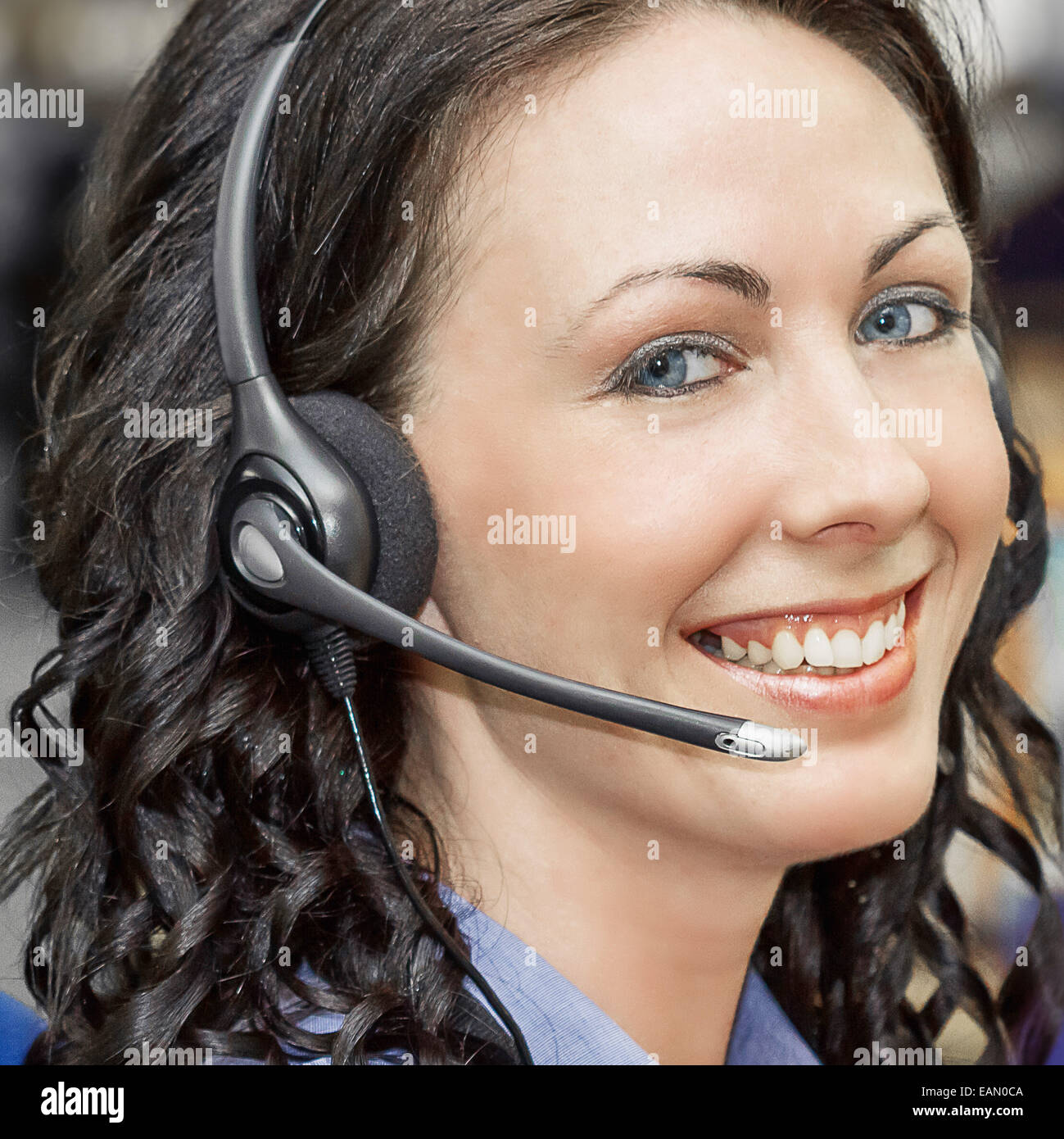 Call Centre staff - young dark haired woman wearing an audio headset ...