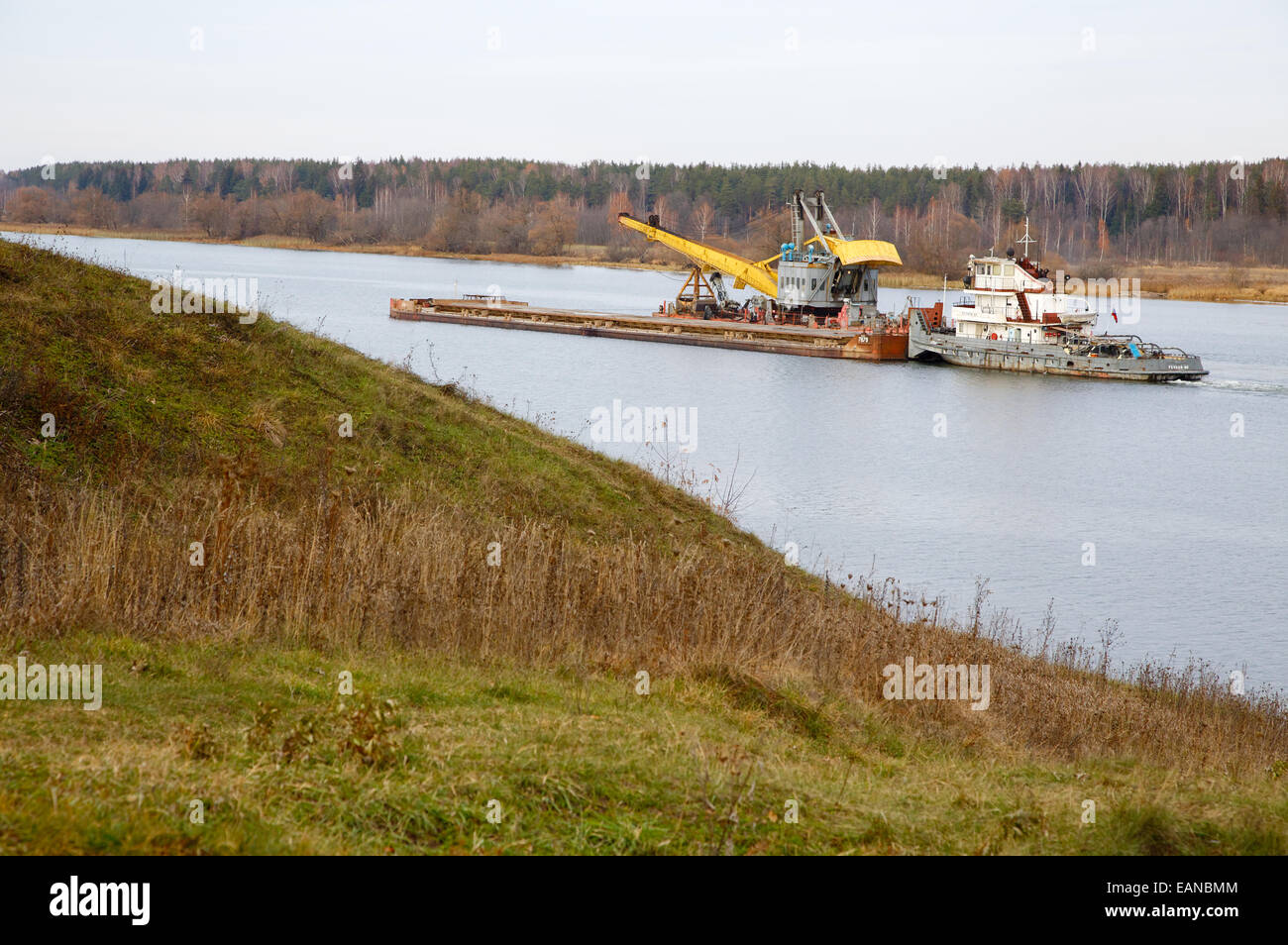 The river tow pushes the barge with a dredge Stock Photo - Alamy