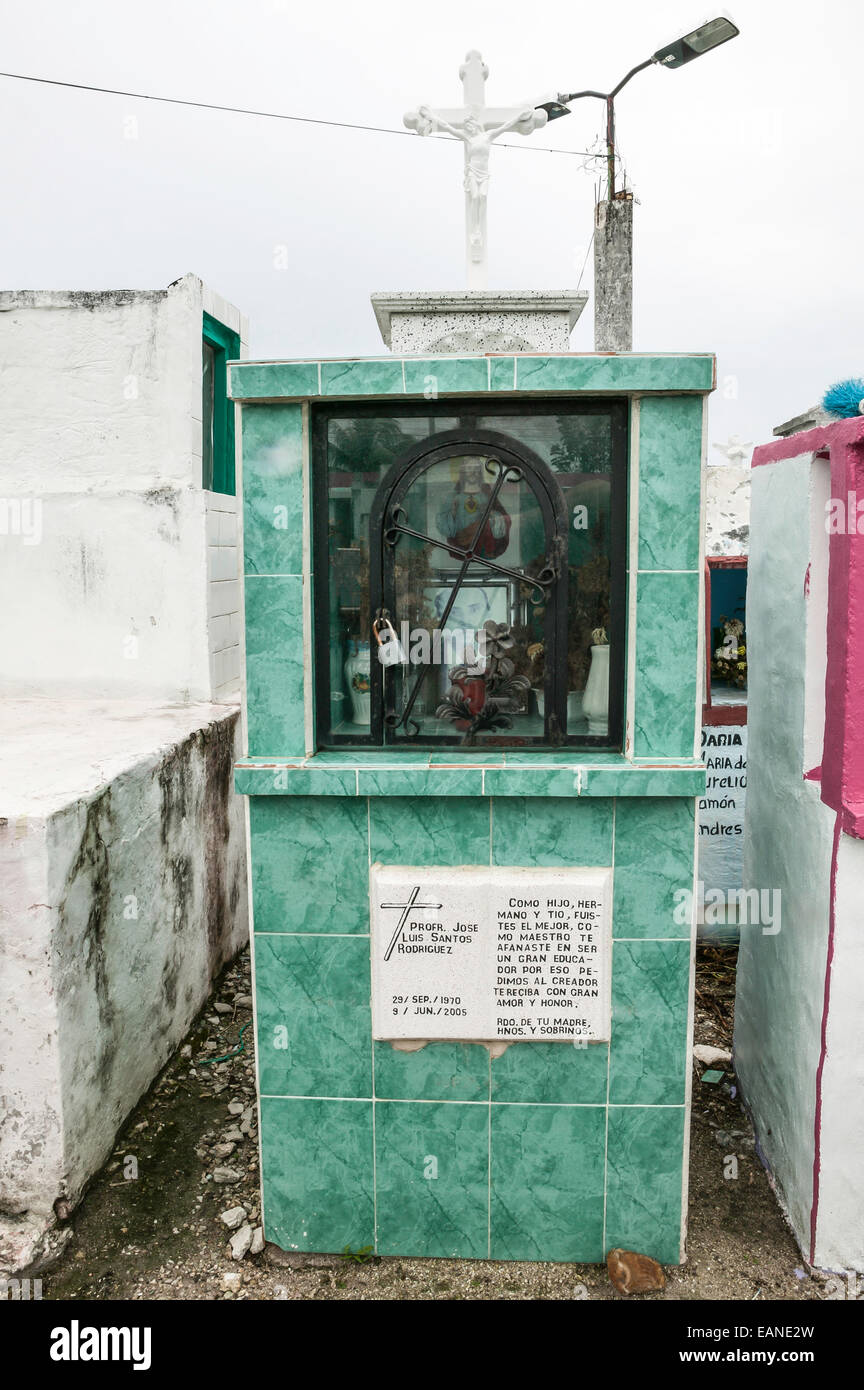 Memorial chamber with grave offerings, photograph, image of Jesus and a ...