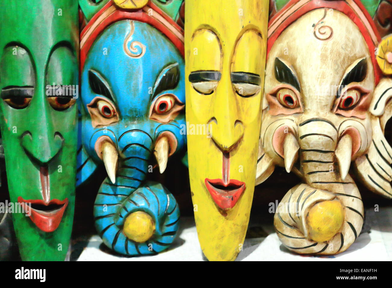 Colorfully painted carved wooden traditional masks representing god ...