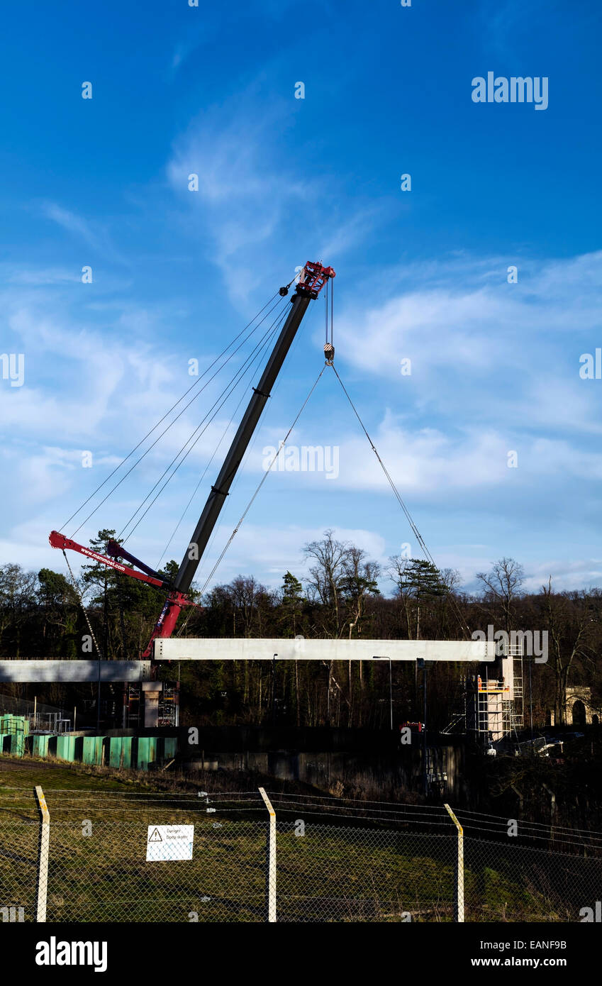 Crane lifting concrete bridge section into place for the new Borders ...