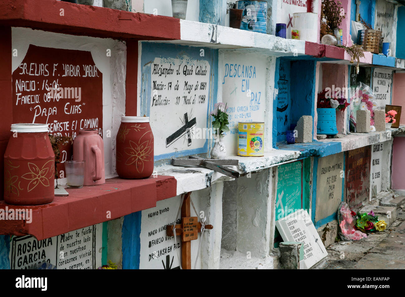 Colorful stacked graves with hand painted grave markers and various ...