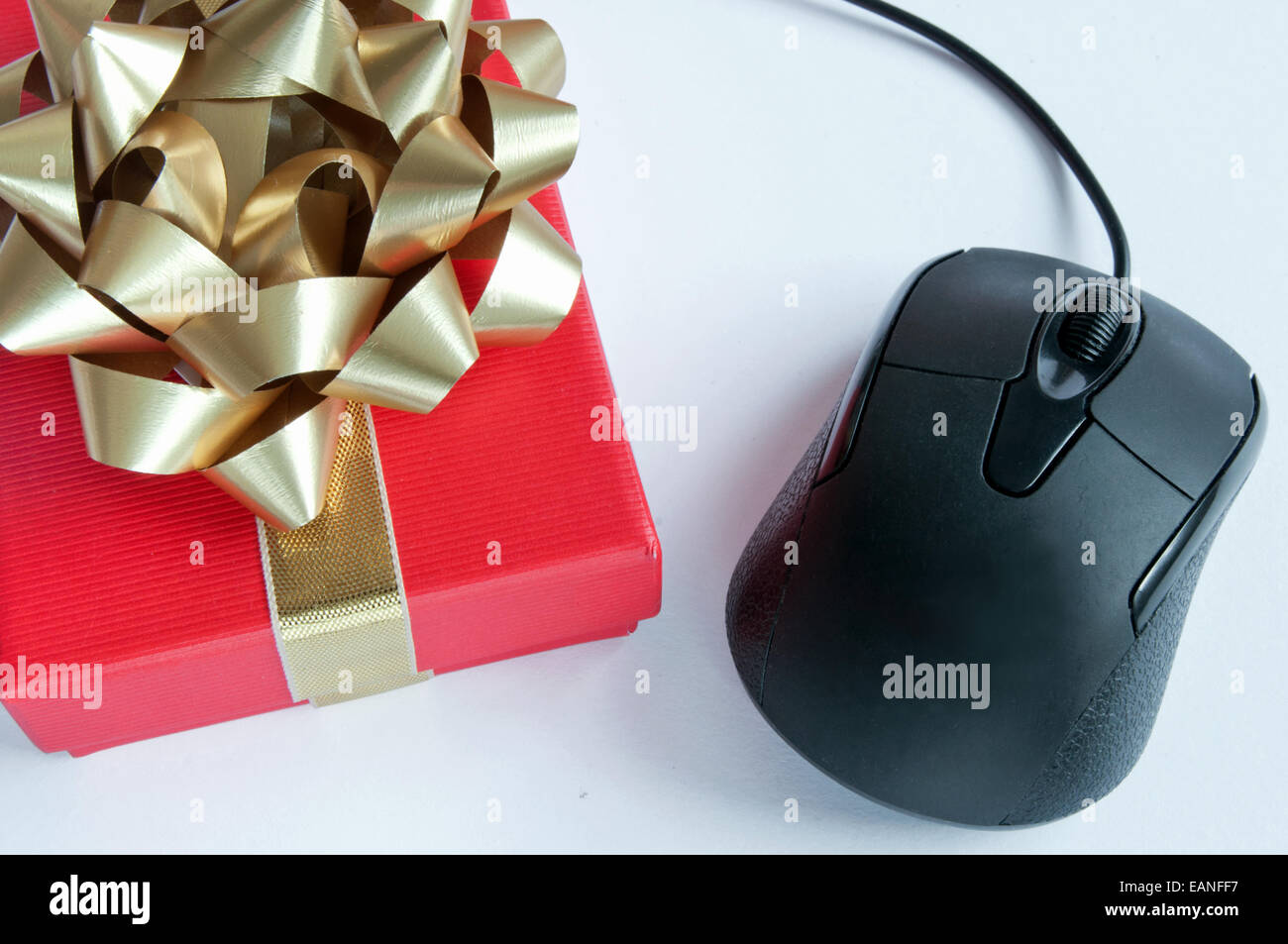 Computer mouse and christmas gift box with gold ribbon bow Stock Photo ...