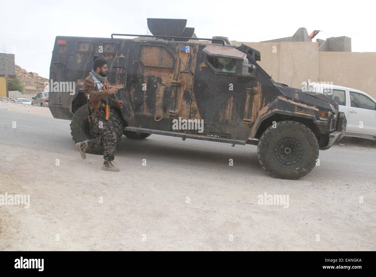 Tripoli, Libya. 18th Nov, 2014. A Libya Dawn fighter walks near an ...