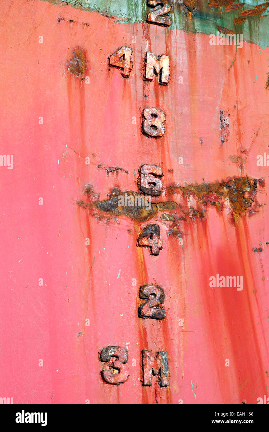 Depth markers on rusty hull of beached ship wreck Stock Photo - Alamy
