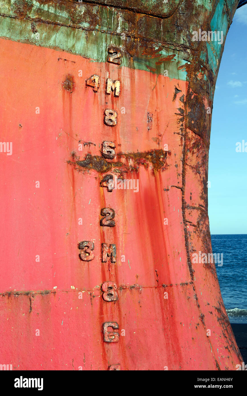 Depth markers on rusty hull of beached ship wreck Stock Photo - Alamy