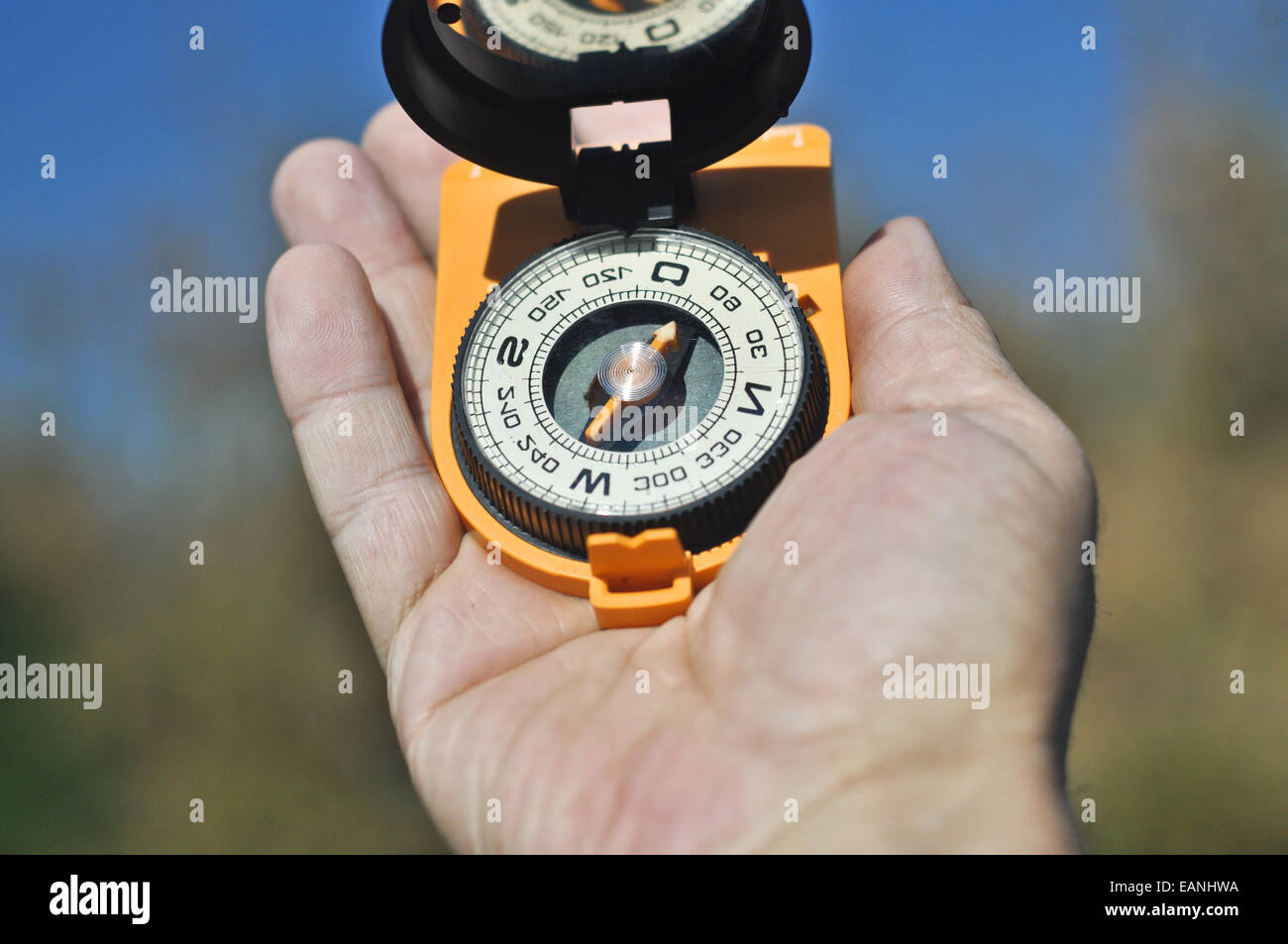 Compass in hand. The magnetic compass lies in a man's hand on a ...