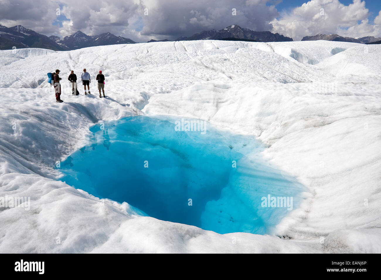 Hikers Stand At The Edge Of A Blue Pool On Root Glacier Wrangell-St ...
