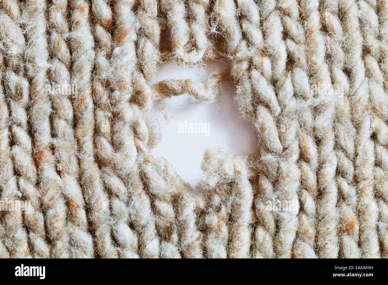 A hole in a damaged wool garment Stock Photo - Alamy