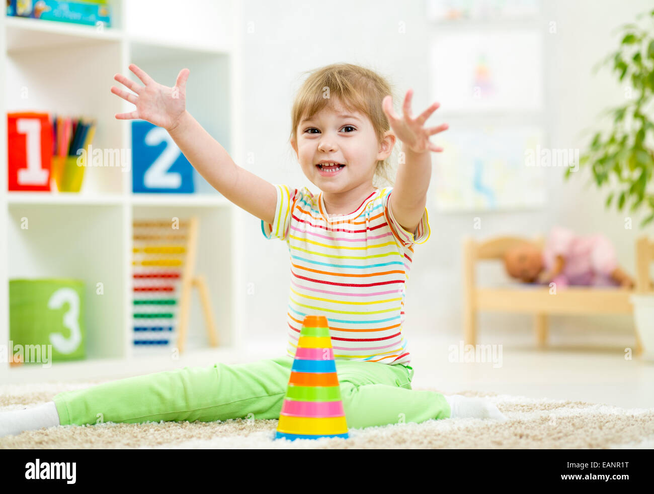 cheerful kid girl playing at children room Stock Photo - Alamy