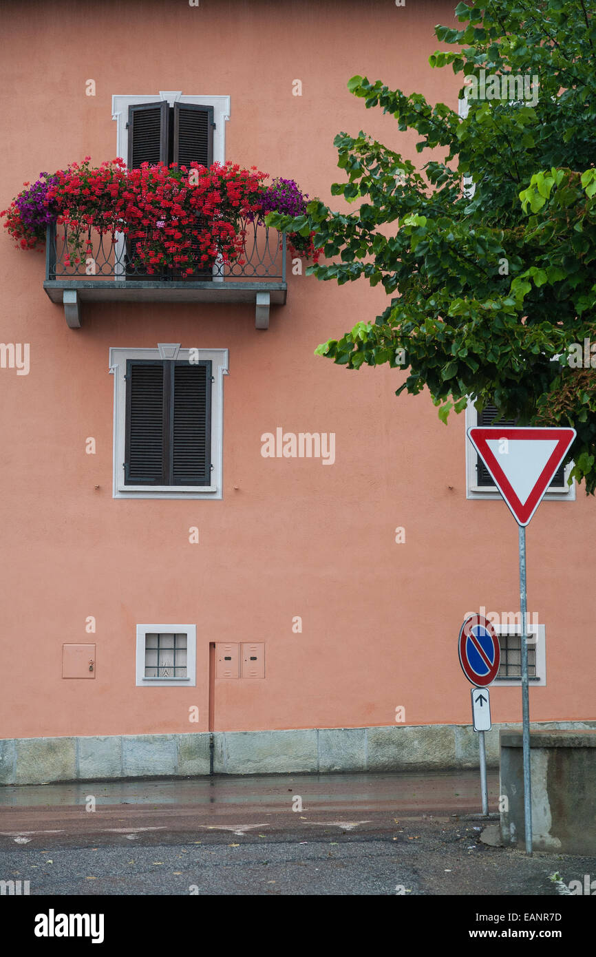 Streetside facade of stucco plaster wall and shuttered windows on ...